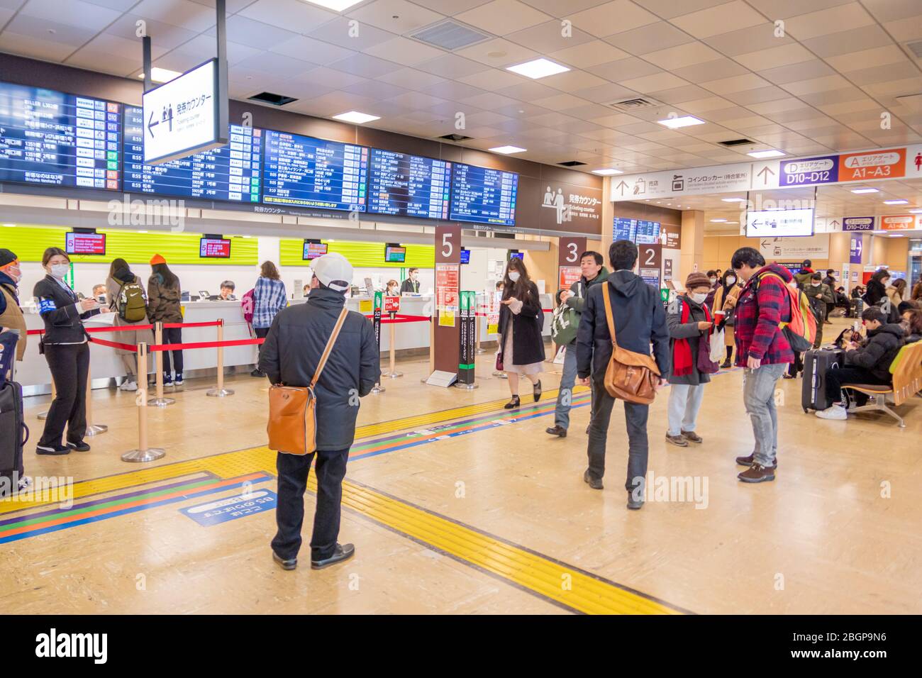 Ticketing office of Shinjuku bus station with few passengers and staff ...