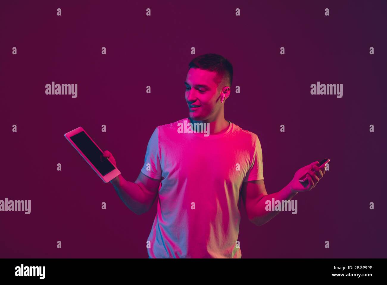 Showing blank screen. Caucasian man's portrait isolated on pink-purple ...