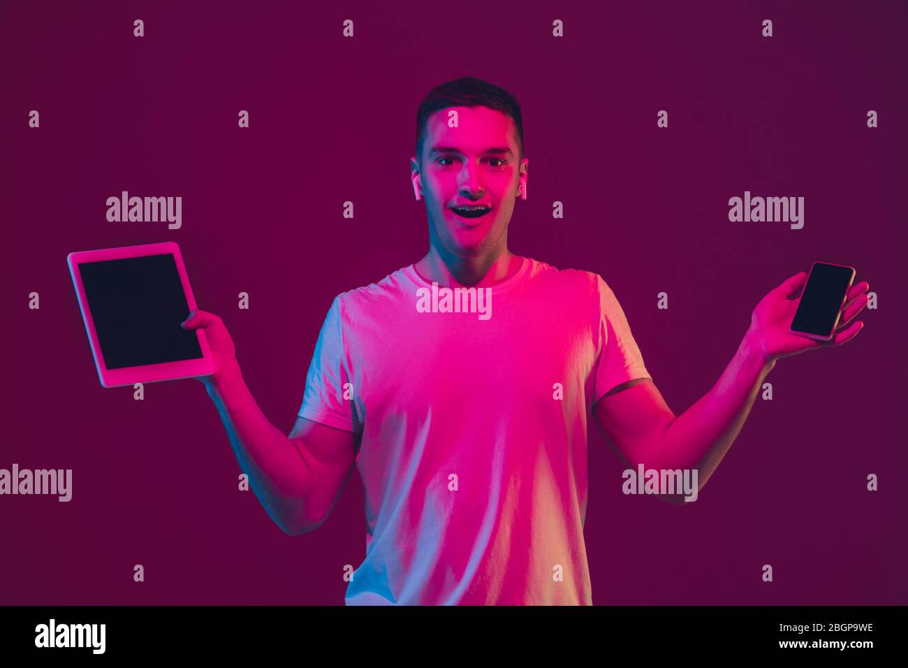 Showing blank screen. Caucasian man's portrait isolated on pink-purple ...