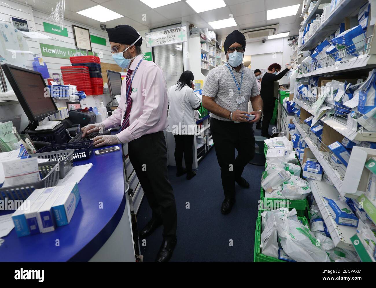 Pharmacists Raj Matharu (left) and Ravinder Ubhi working at the ...