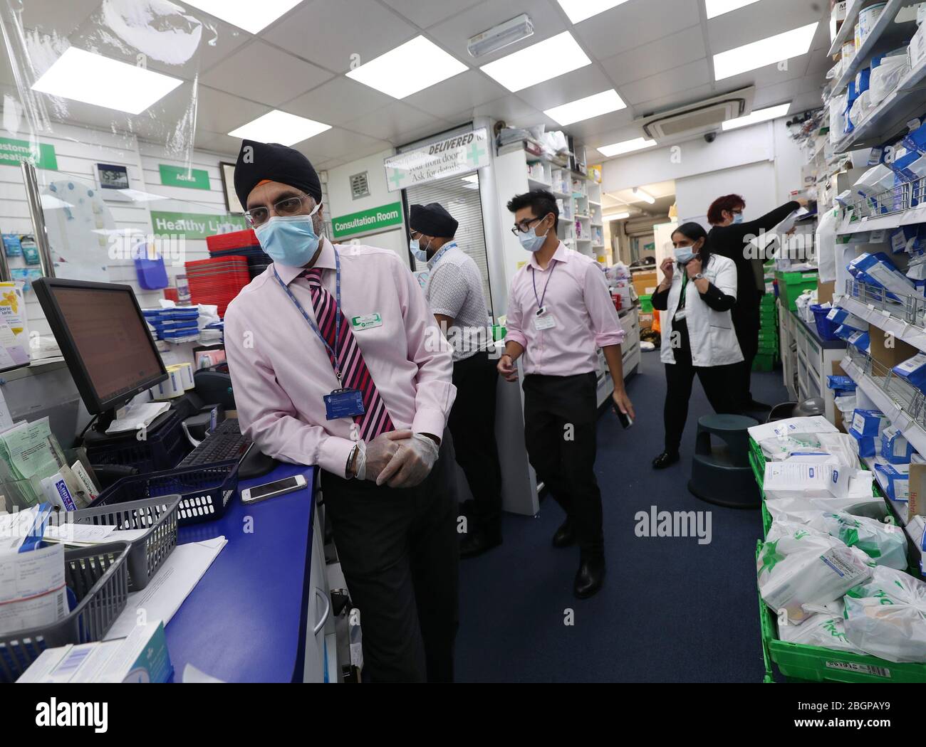 Pharmacist Raj Matharu (left) and his colleagues working at the ...
