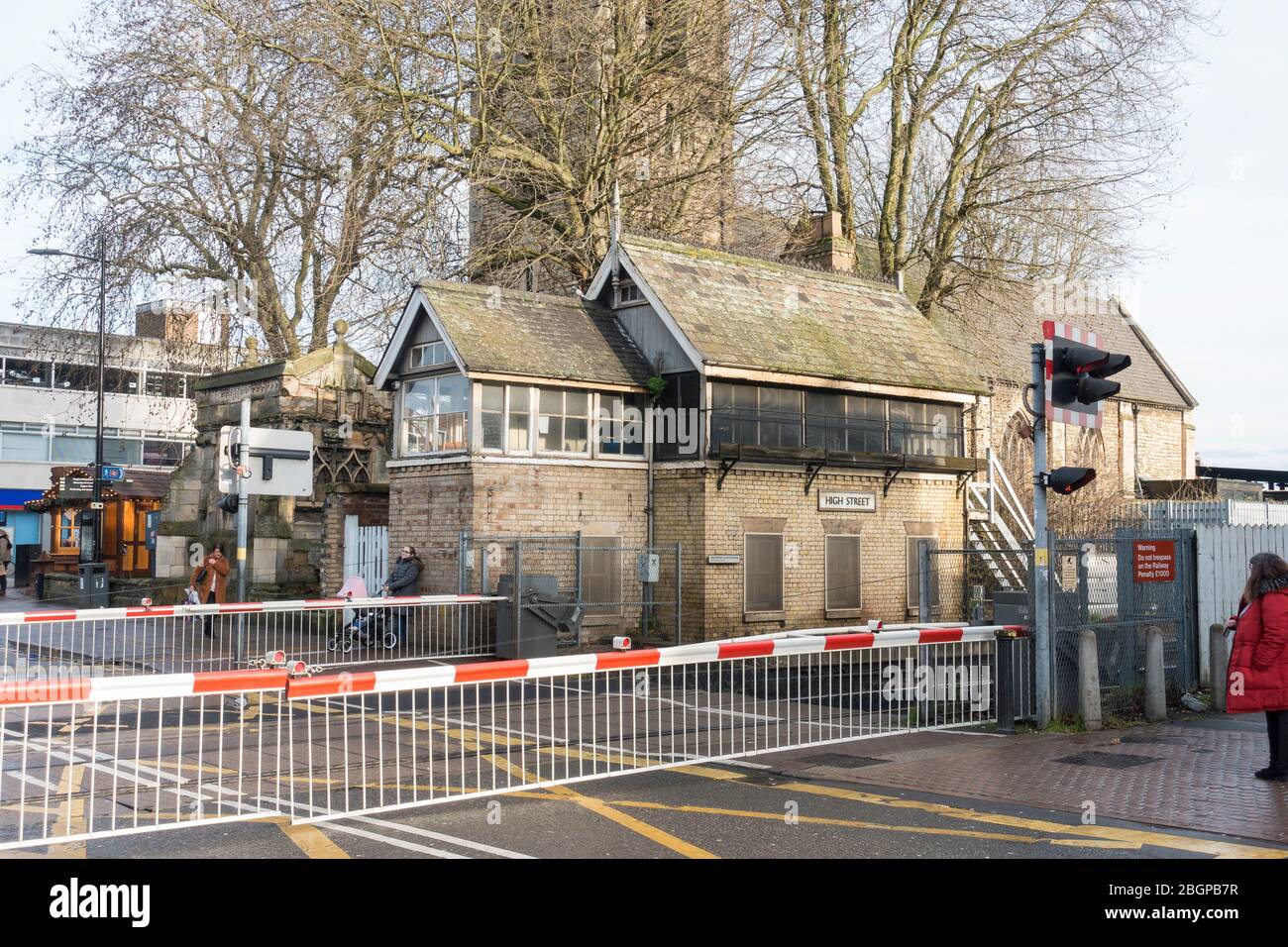 Disused High Street railway signal box beside operational level ...