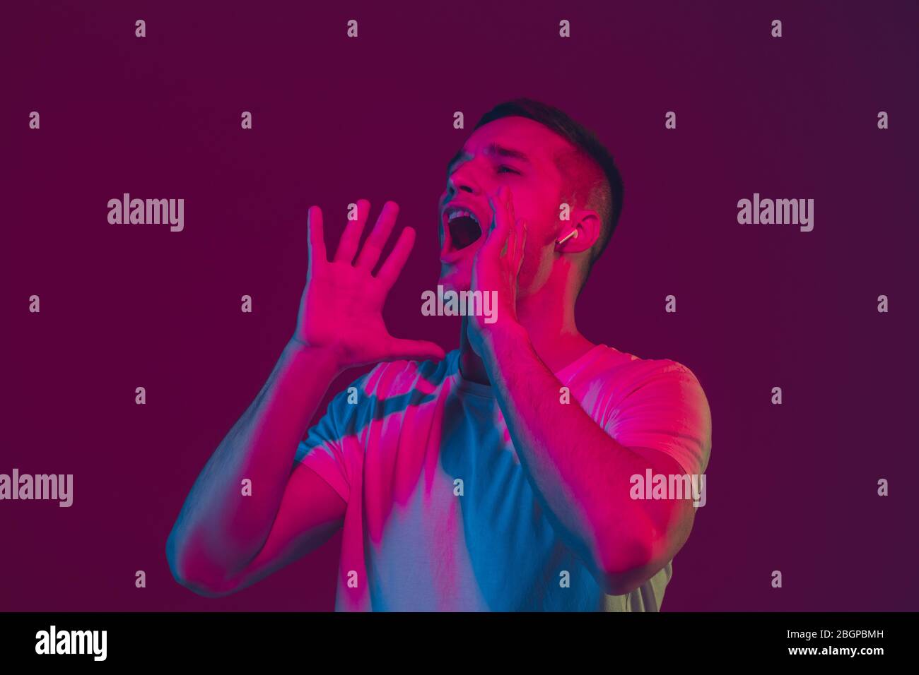 Calling for sales, shouting. Caucasian man's portrait isolated on pink ...
