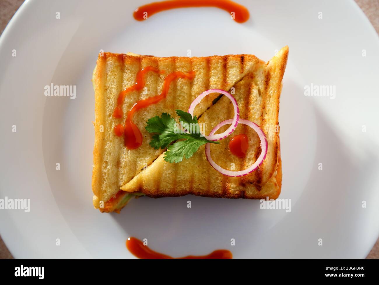 A sandwich in a white ceramic plate Stock Photo - Alamy