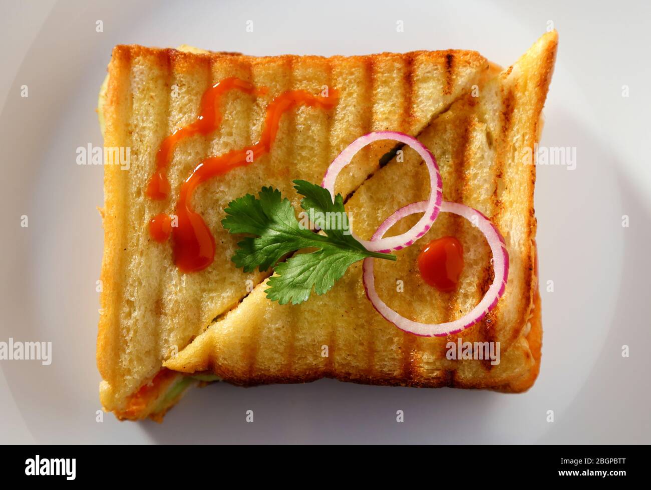 A sandwich in a white ceramic plate Stock Photo - Alamy