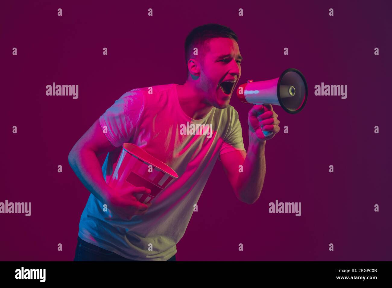 Calling for sales, shouting. Caucasian man's portrait isolated on pink ...