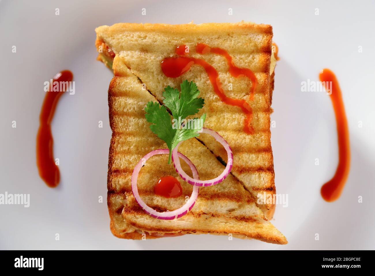 A sandwich in a white ceramic plate Stock Photo - Alamy