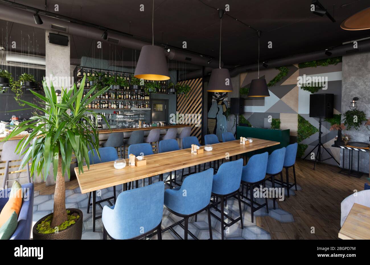 Cute restaurant interior with sofas and wooden tables Stock Photo - Alamy