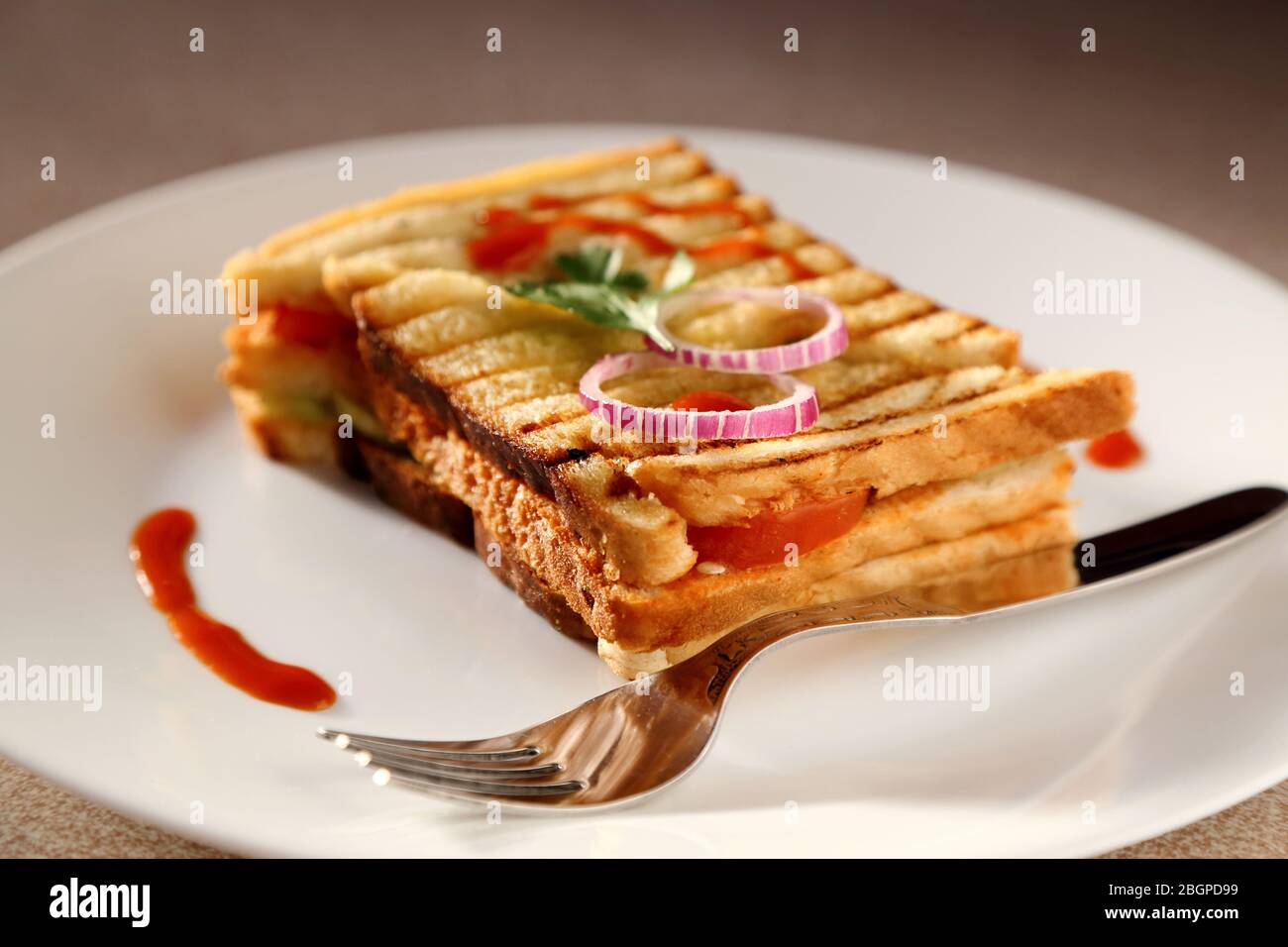 A sandwich in a white ceramic plate Stock Photo - Alamy