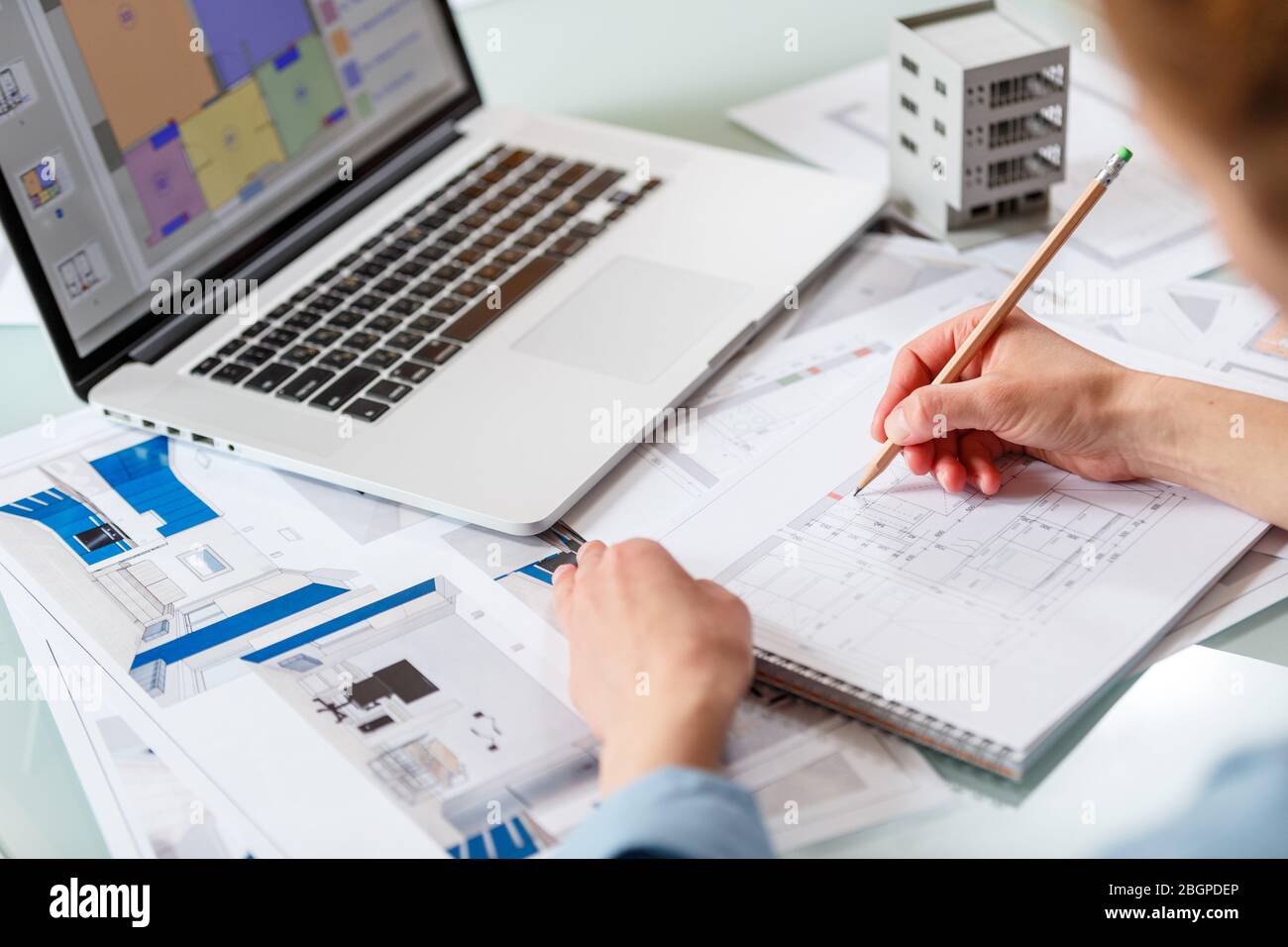 Interior designer working with an apartment plans in a studio, with ...