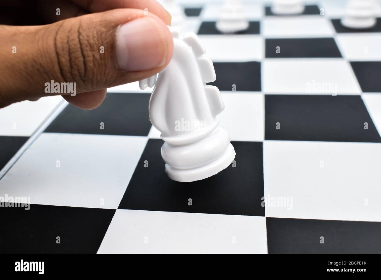 One person moving a placed white knight from a black square of the ...