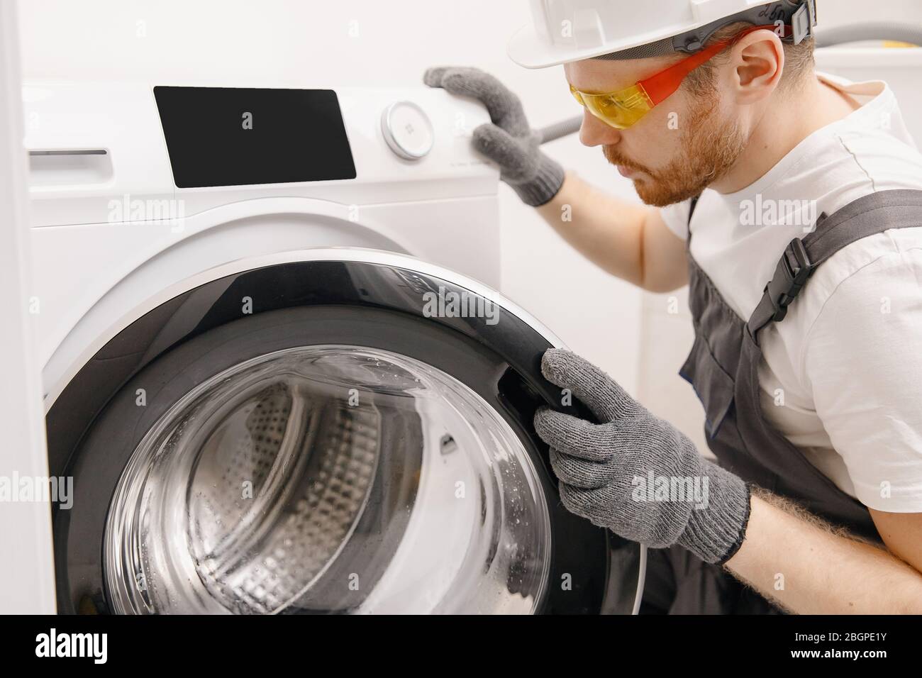 Man Fixing Washing Machine High Resolution Stock Photography and Images ...