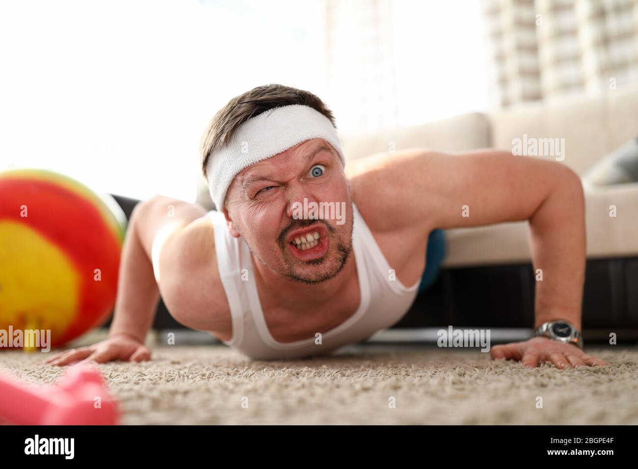 Funny grimacing man making push-ups home Stock Photo - Alamy Funny grimacing man making push-ups home Stock Photo - Alamy