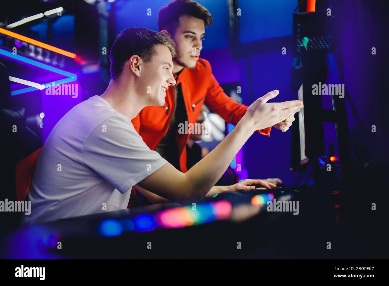 Team of two guys playing online video games analyzes strategy of ...