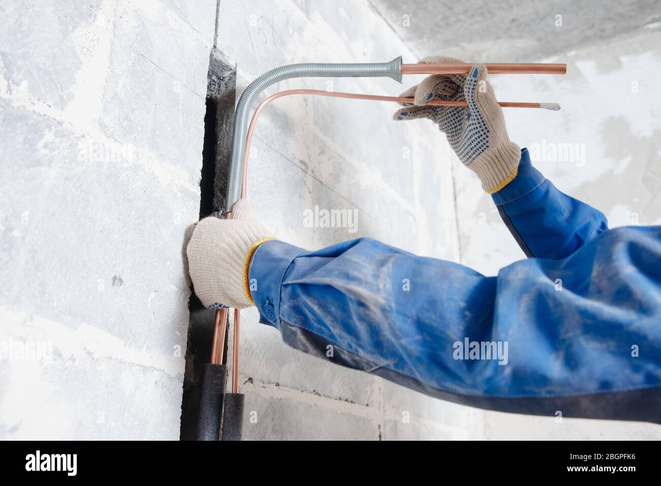 Worker man Installation of pipe channel for connecting air conditioner ...