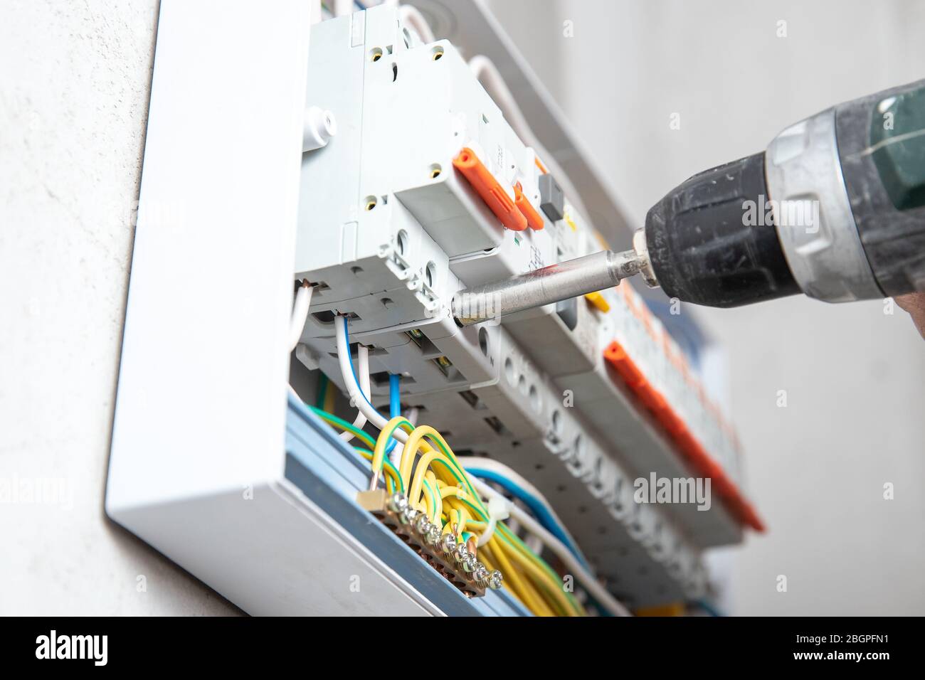 Electrician hand mounts consumer electric control panel switchboard for ...