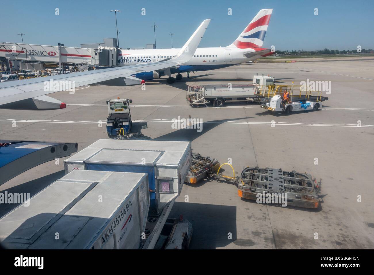 Baggage being loaded onto a BA Airbus A320 at London Heathrow Airport ...