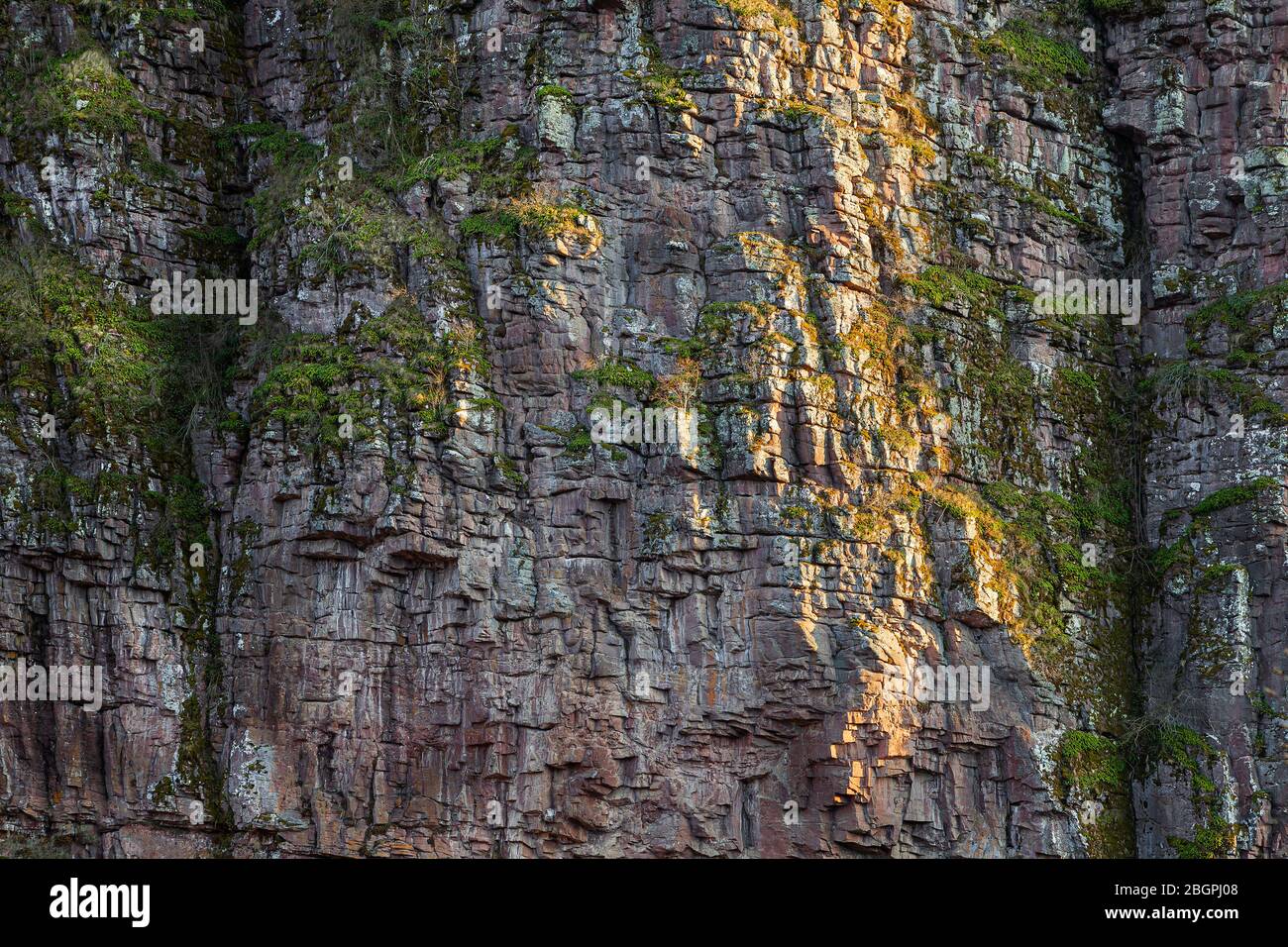 Impressive details of layers of a textured, vertical, rocky cliff ...