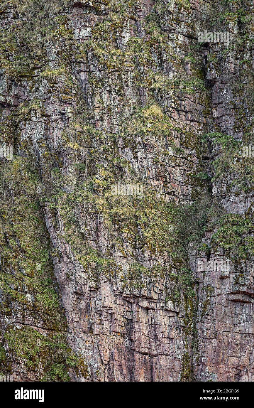 Impressive details of layers of a textured, vertical, rocky cliff ...