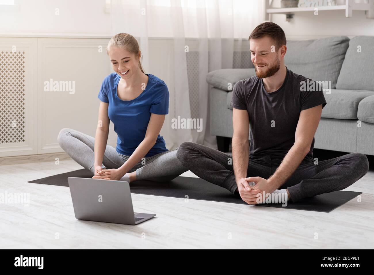 Sporty couple meditating together hi-res stock photography and images ...