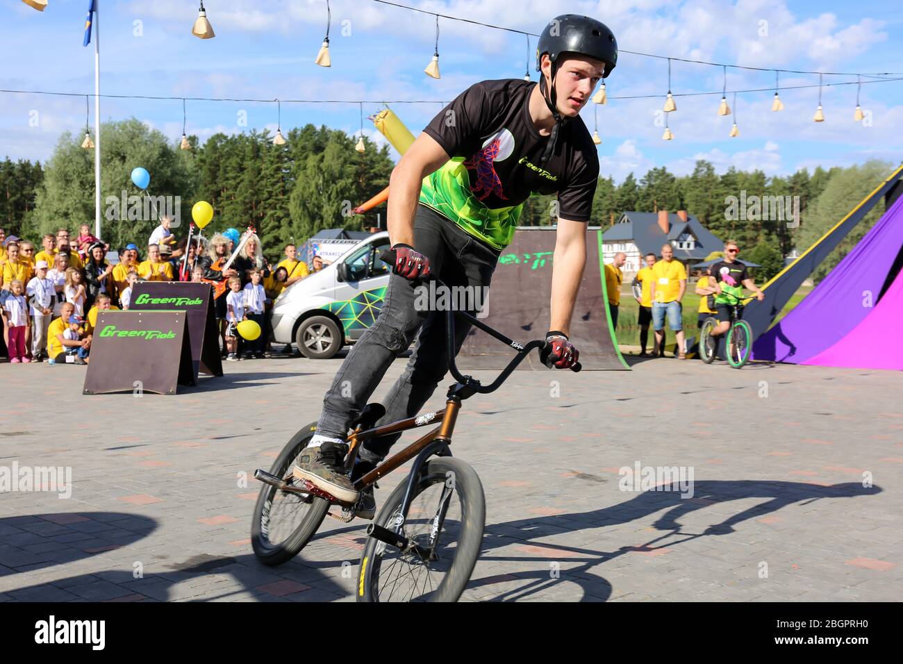 Young men professional bmx riders outdoor performance. Trick ...