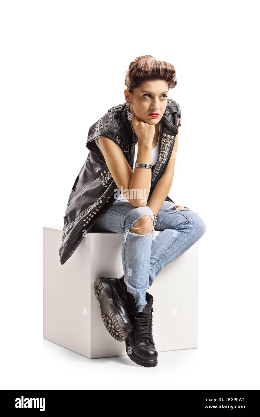 Serious punk woman sitting and looking away isolated on white ...