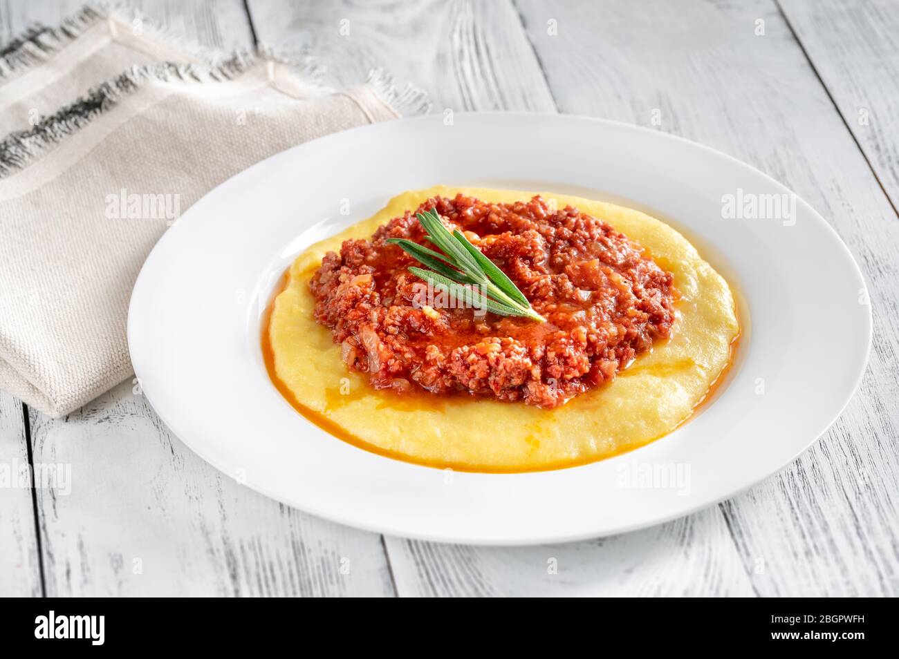 Italian cornmeal polenta with bolognese sauce Stock Photo - Alamy