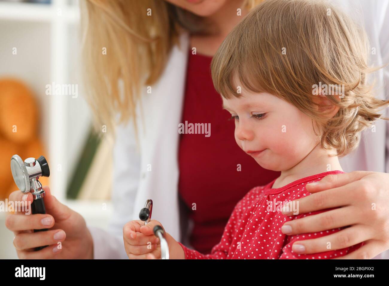 Little child with stethoscope at doctor reception Stock Photo - Alamy