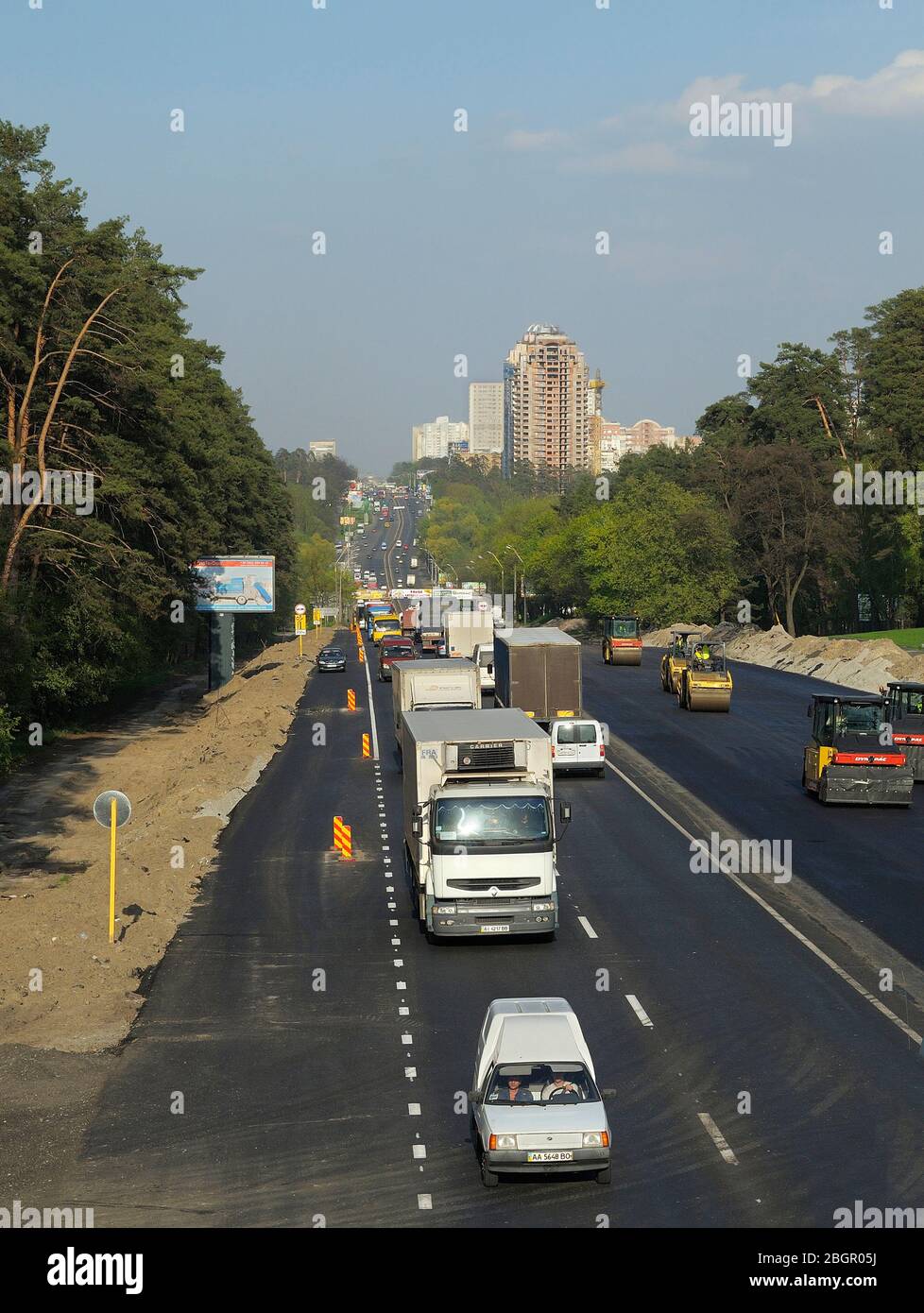 Pavers, road-rollers, trucks and other heavy duty vehicles asphalting ...