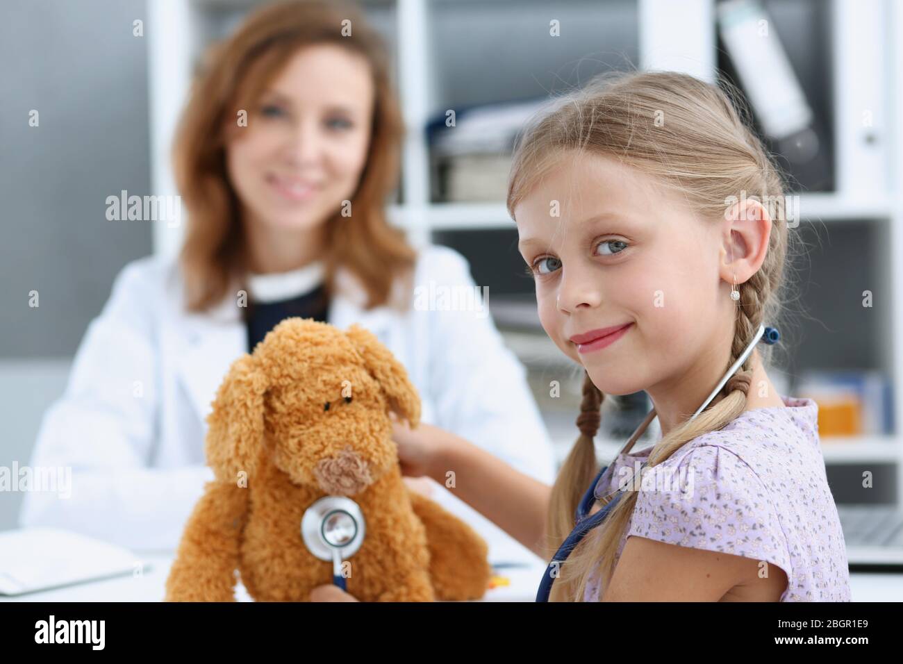 Little child with stethoscope at doctor reception Stock Photo - Alamy