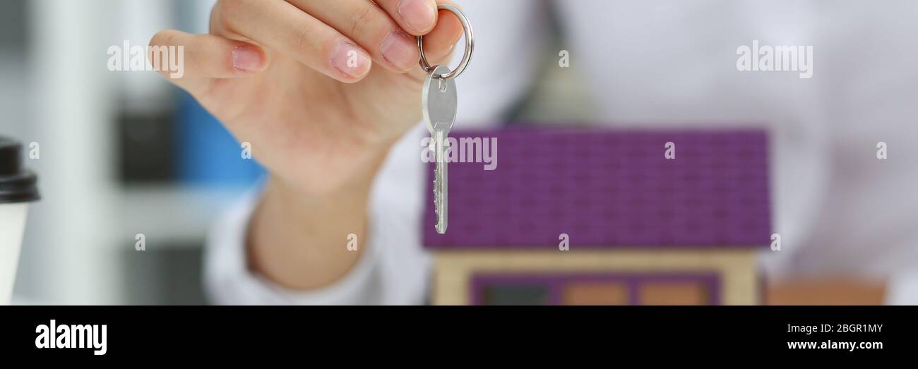 Female hand holds the key to the lock Stock Photo - Alamy