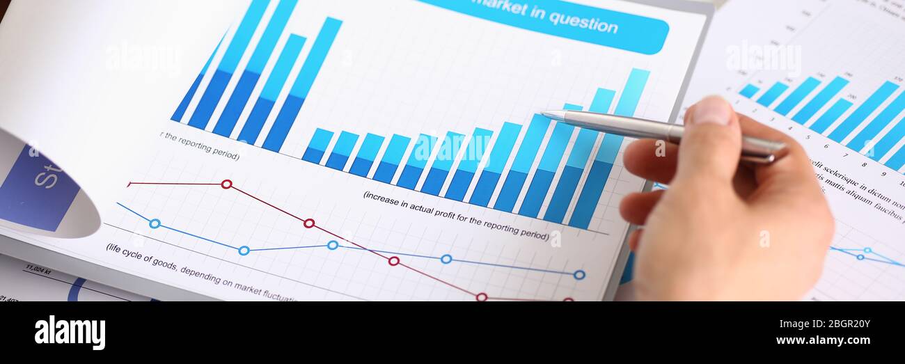 Male hands hold documents with financial statistics Stock Photo - Alamy