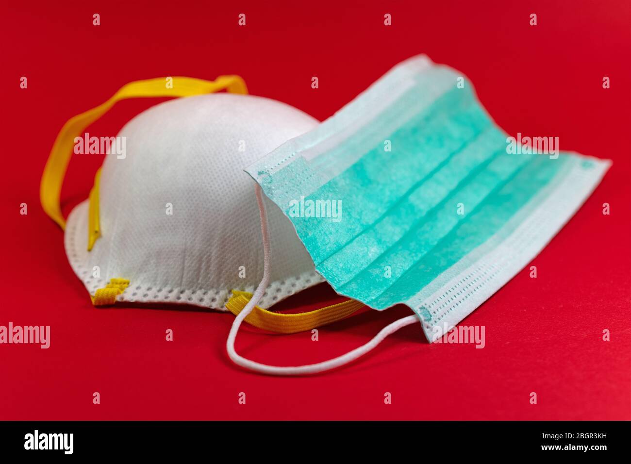 Disposable breathing masks isolated against a red background Stock ...