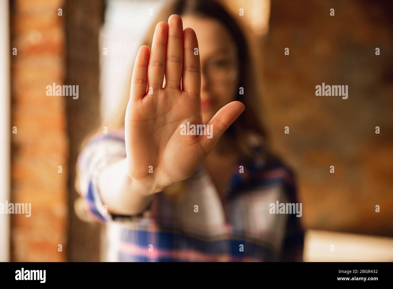 Close up view of young woman making stop gesture with her hand. Cropped ...