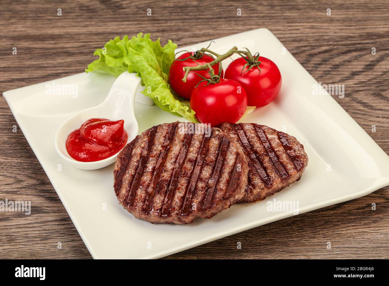 Grilled burger cutlet with tomato sauce Stock Photo - Alamy