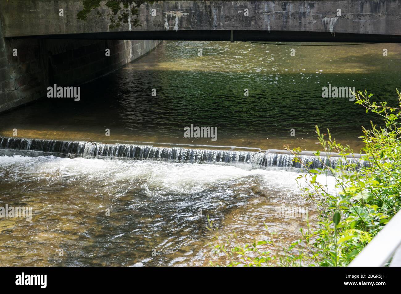 Beautiful waterfall on the summer landscape with old bridge. Nature ...