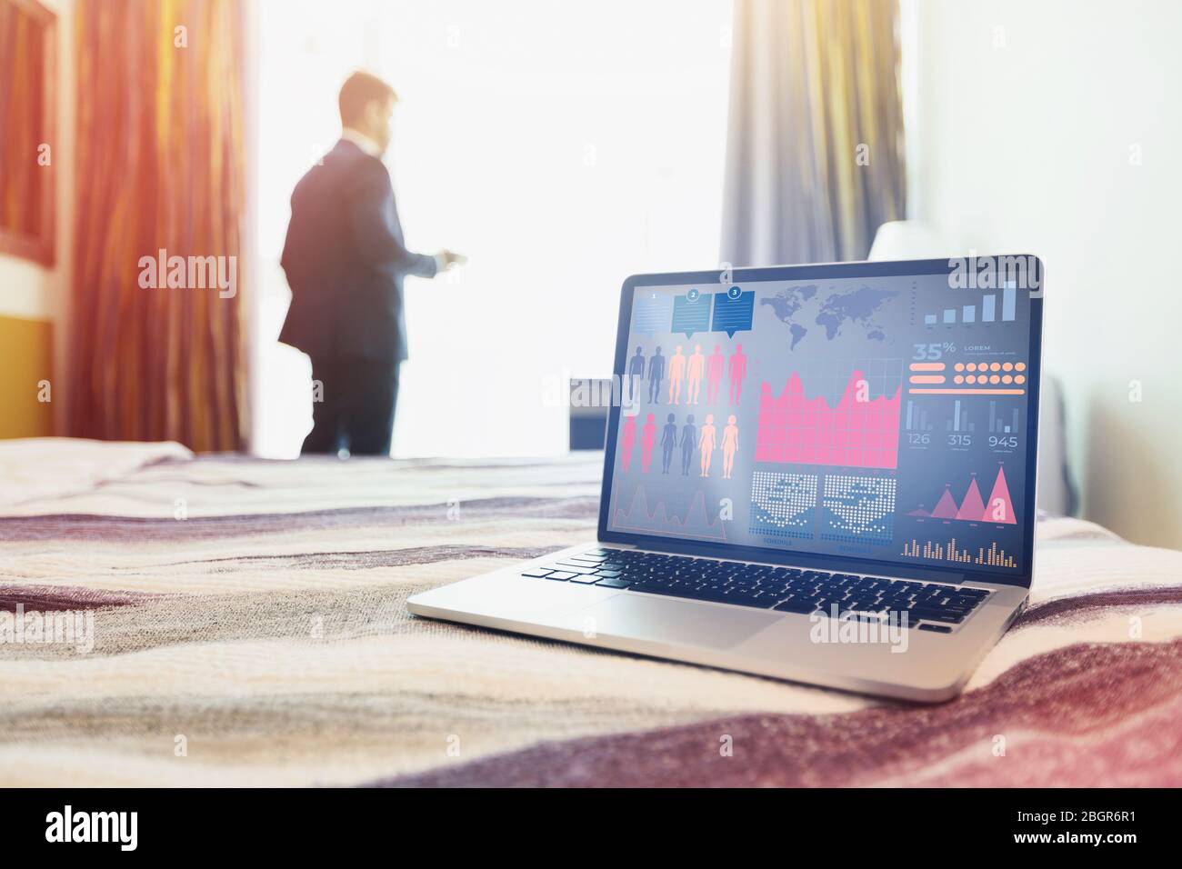 Laptop with graphics and charts on screen on bed sheets Stock Photo - Alamy