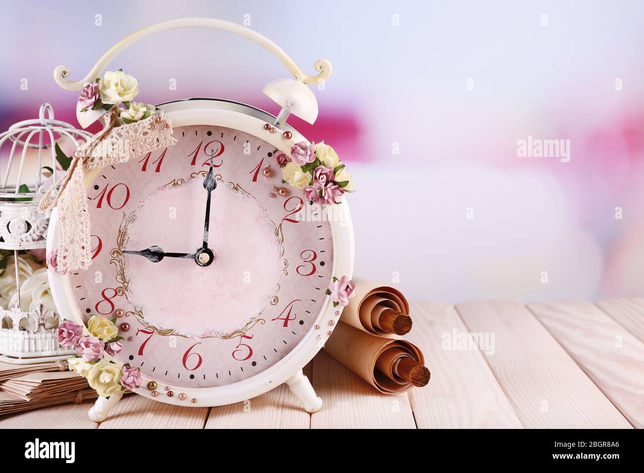 Beautiful vintage alarm clock with flowers on light background Stock ...