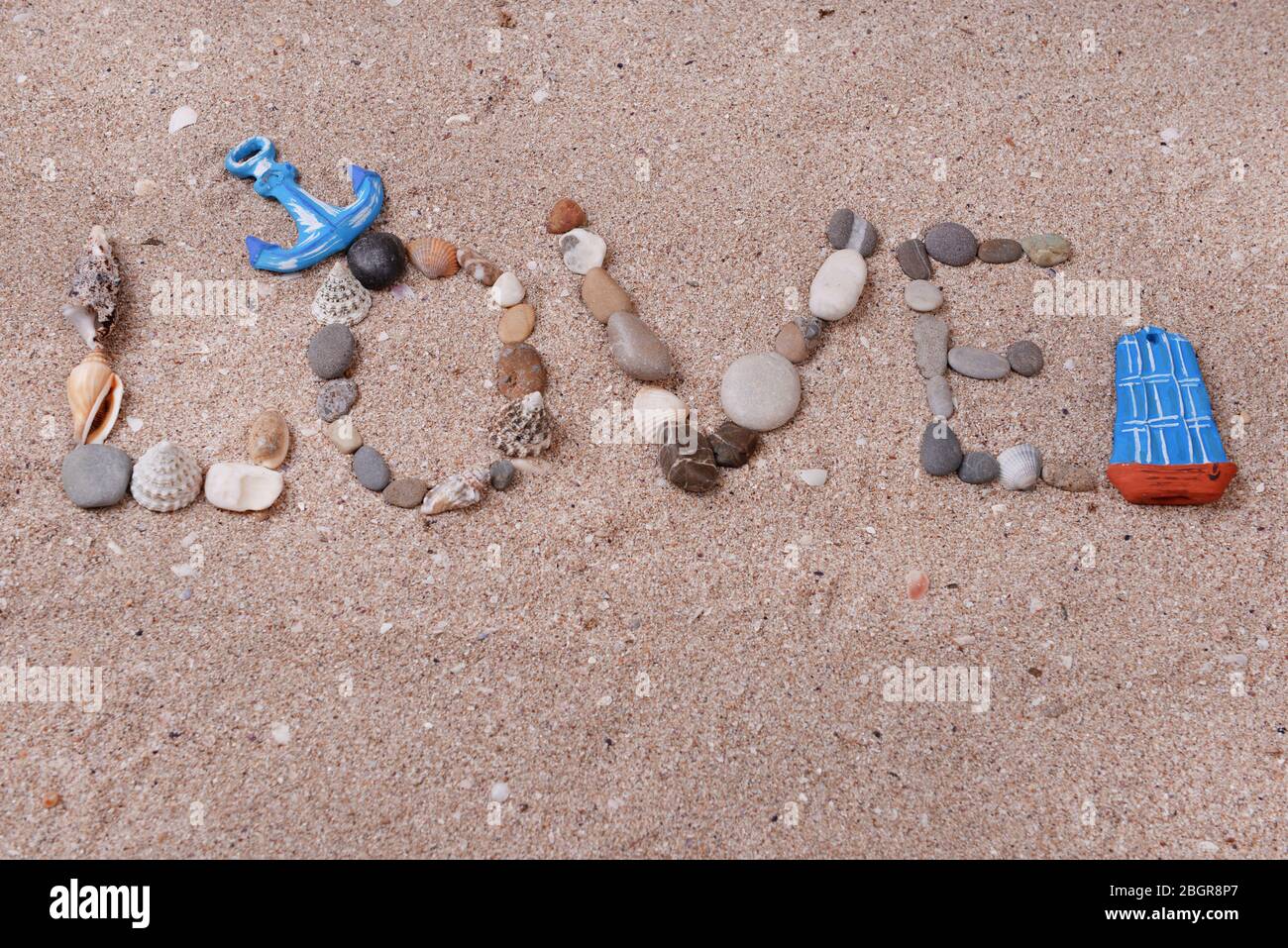 Word love made from sea shells and stones on sand Stock Photo - Alamy