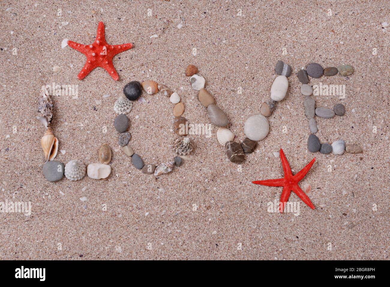 Word love made from sea shells and stones on sand Stock Photo - Alamy