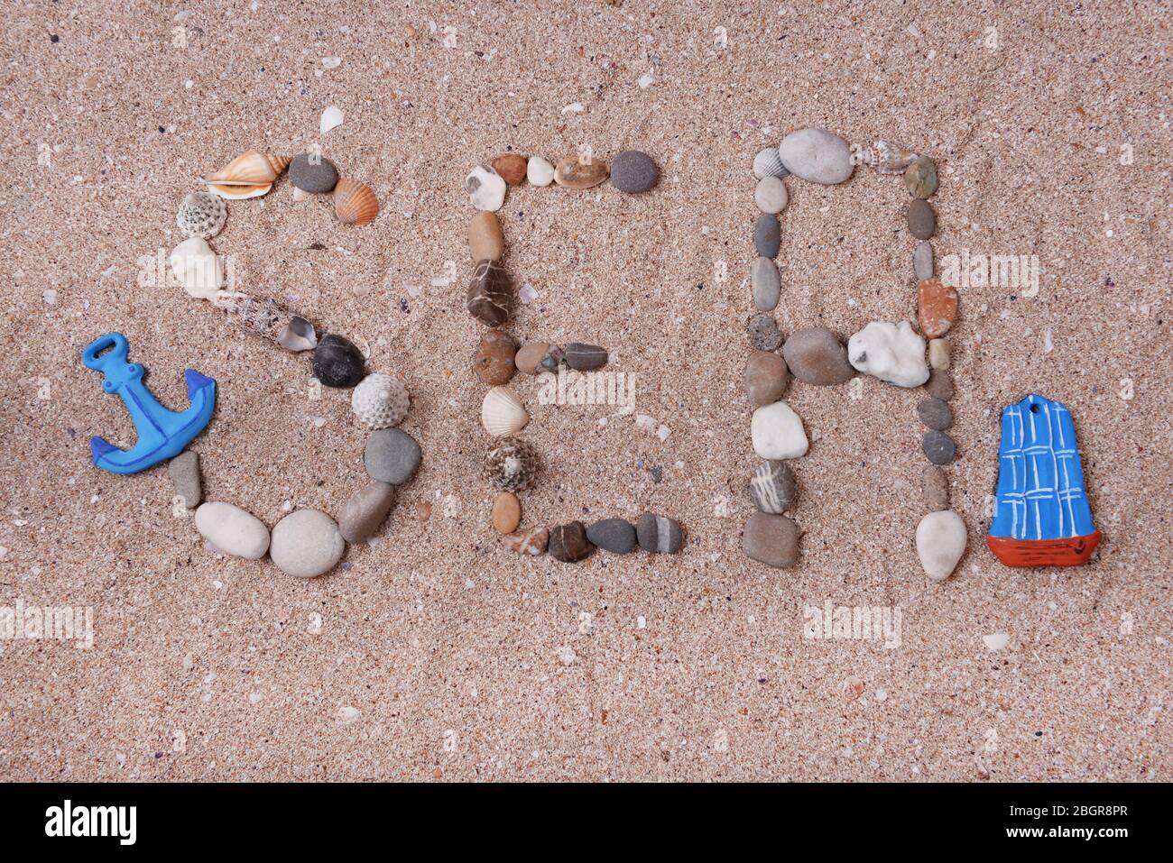 Word sea made from sea shells and stones on sand Stock Photo - Alamy