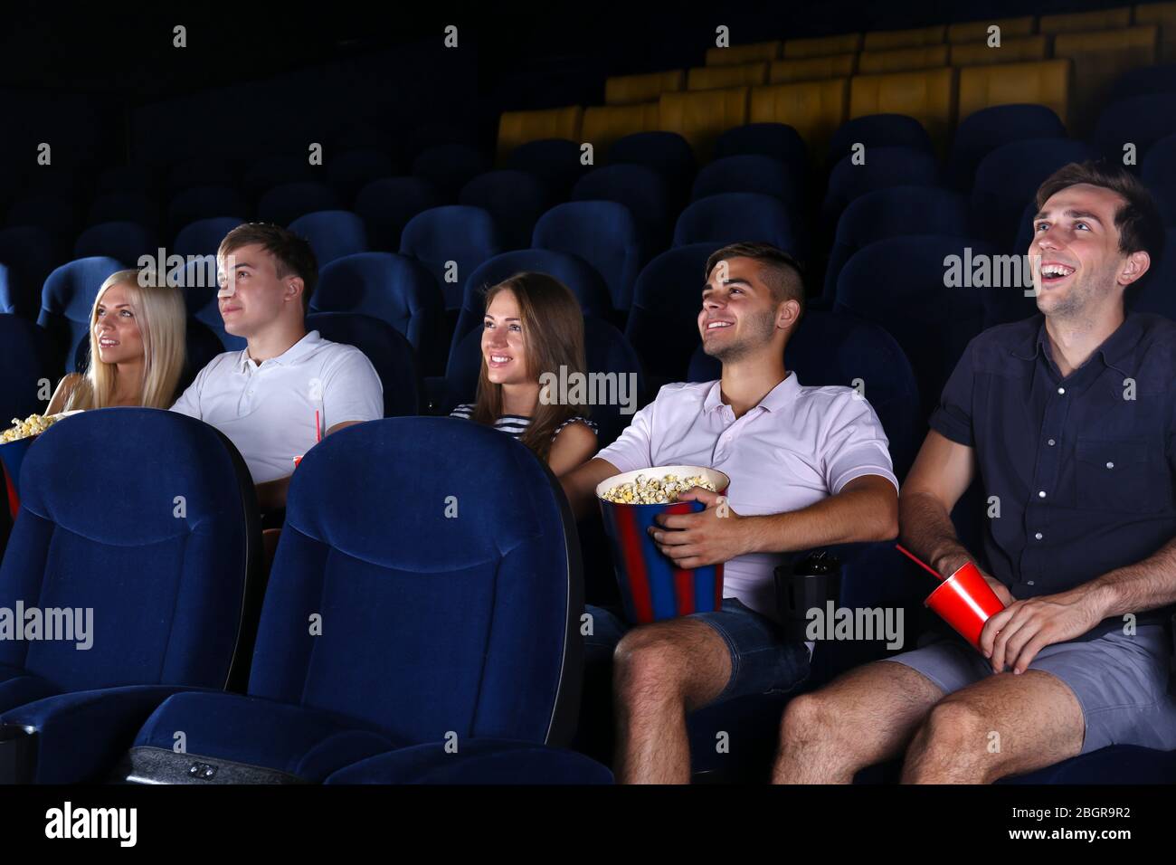 Young people watching movie in cinema Stock Photo - Alamy