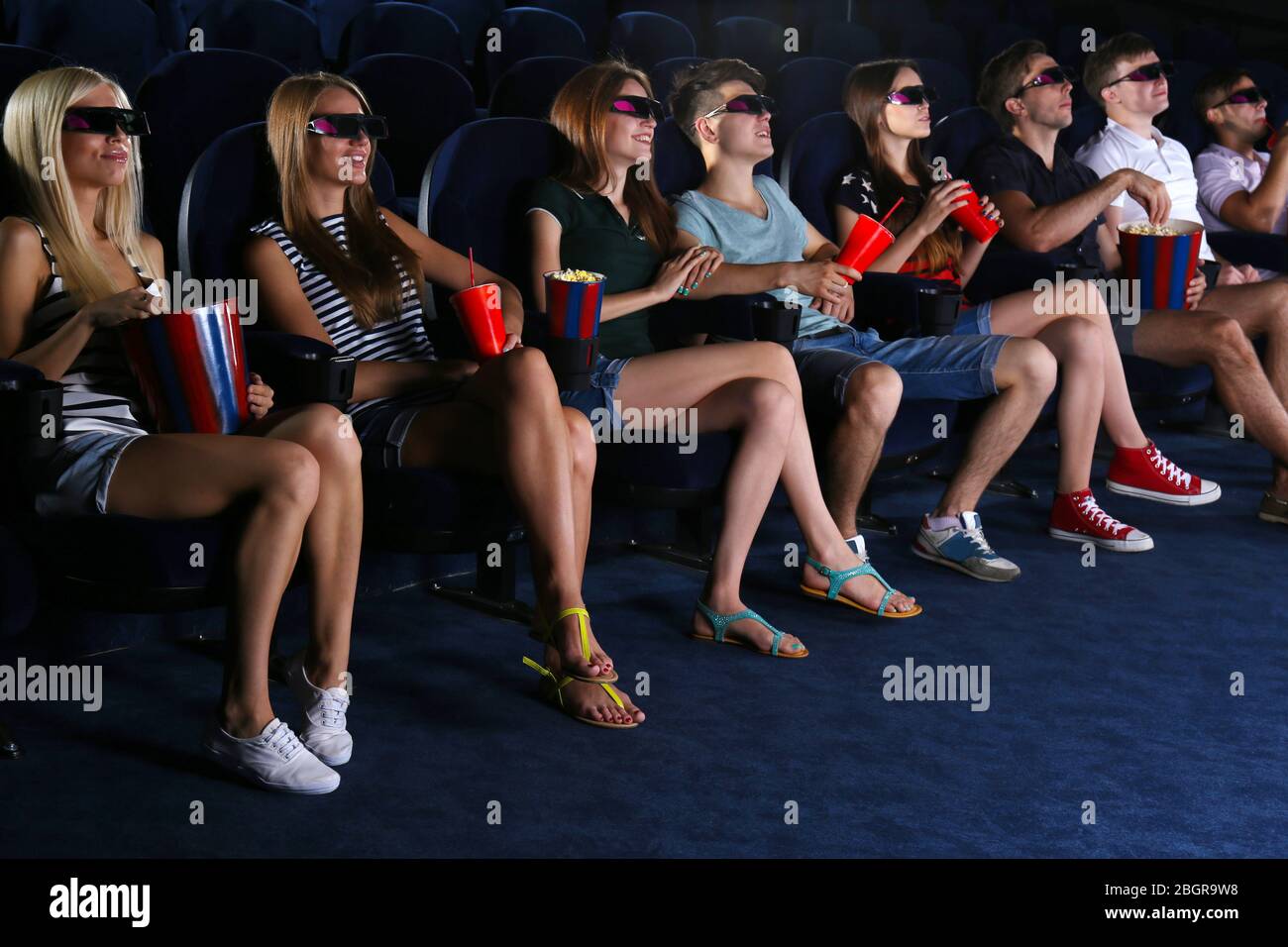 Young people watching movie in cinema Stock Photo - Alamy