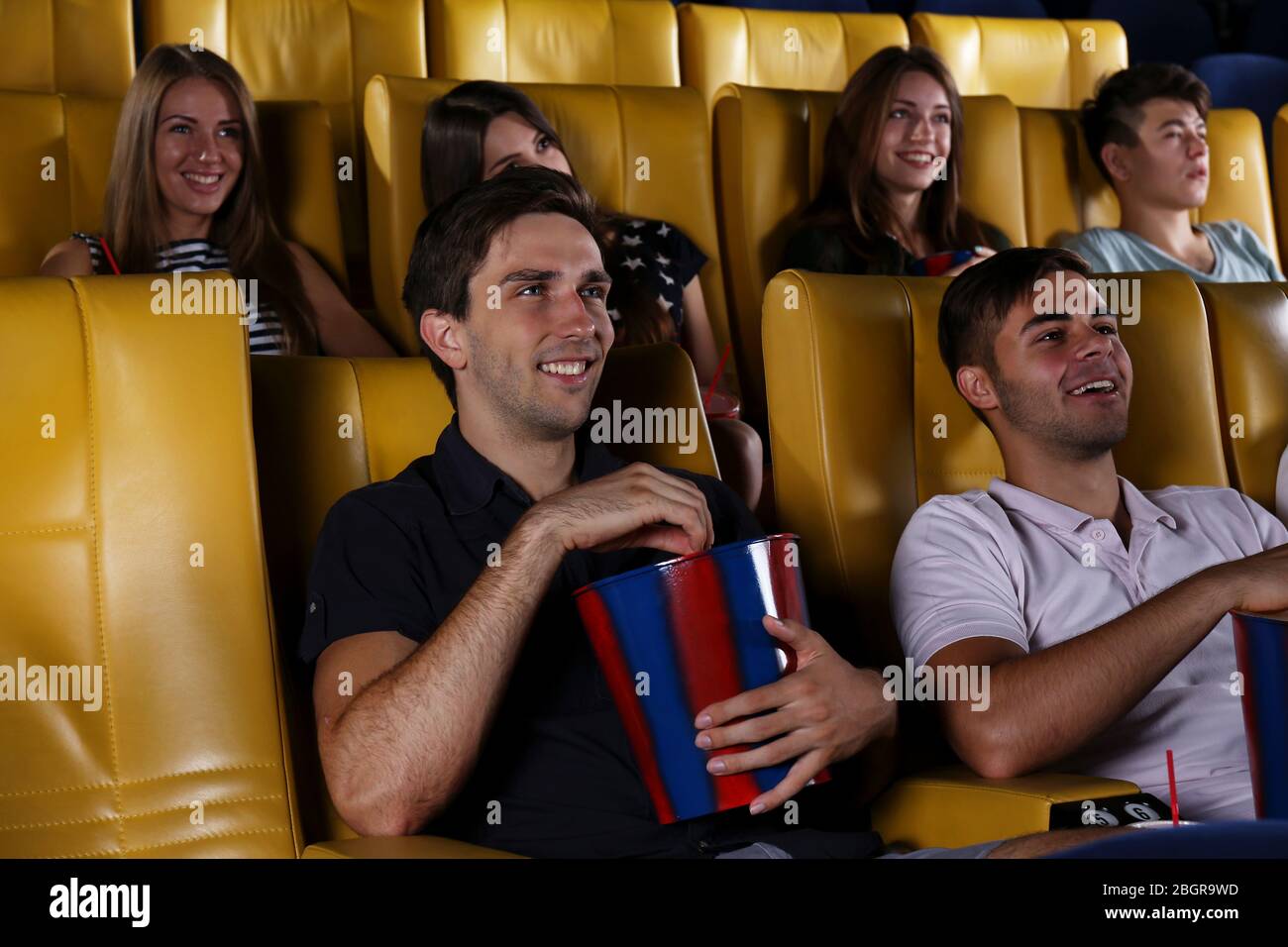 Young people watching movie in cinema Stock Photo - Alamy