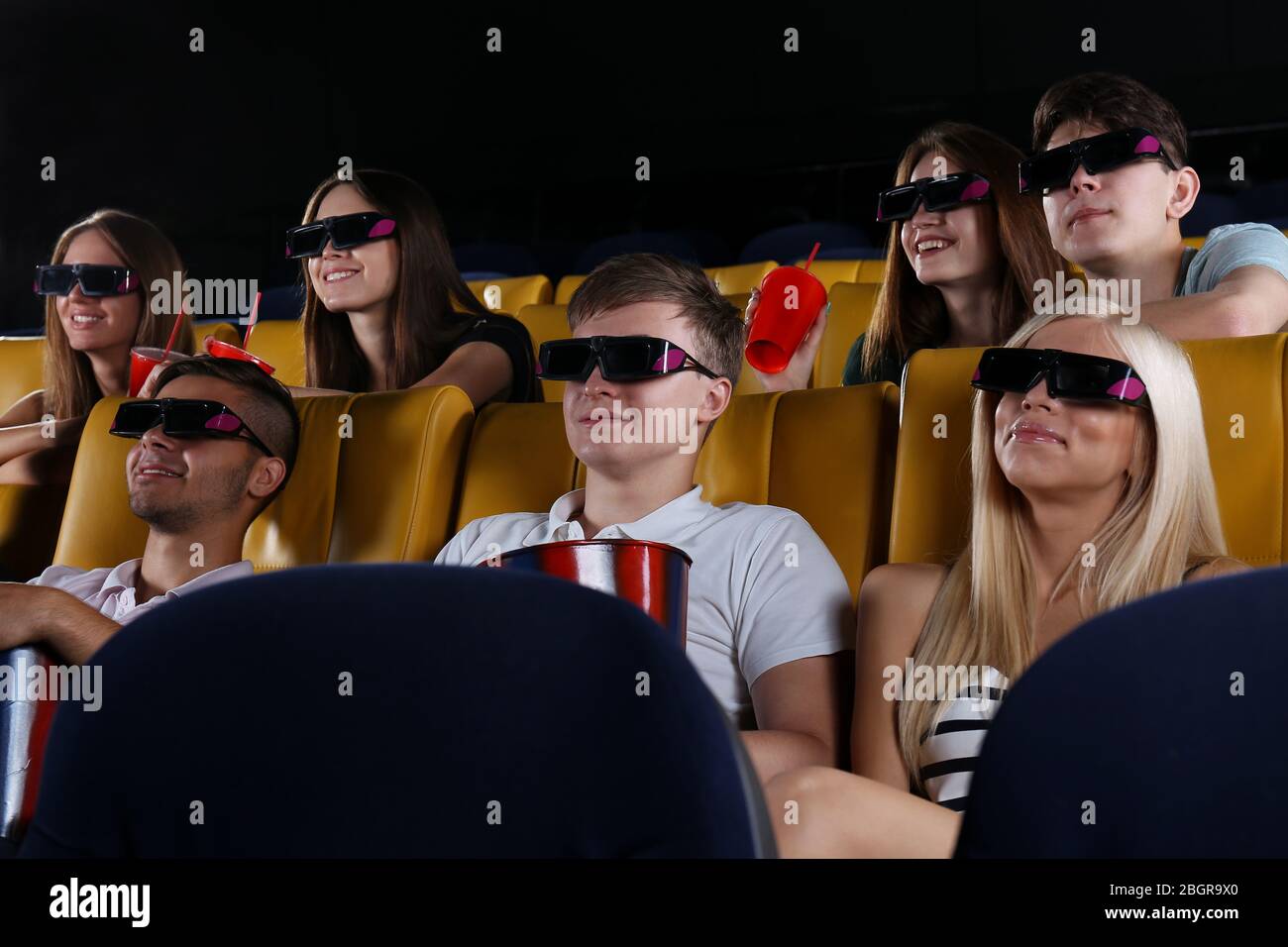 Young people watching movie in cinema Stock Photo - Alamy