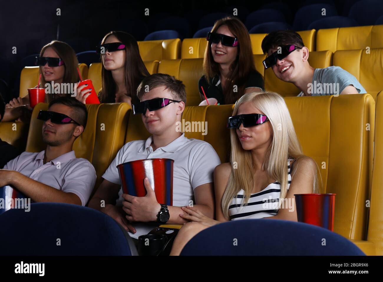 Young people watching movie in cinema Stock Photo - Alamy