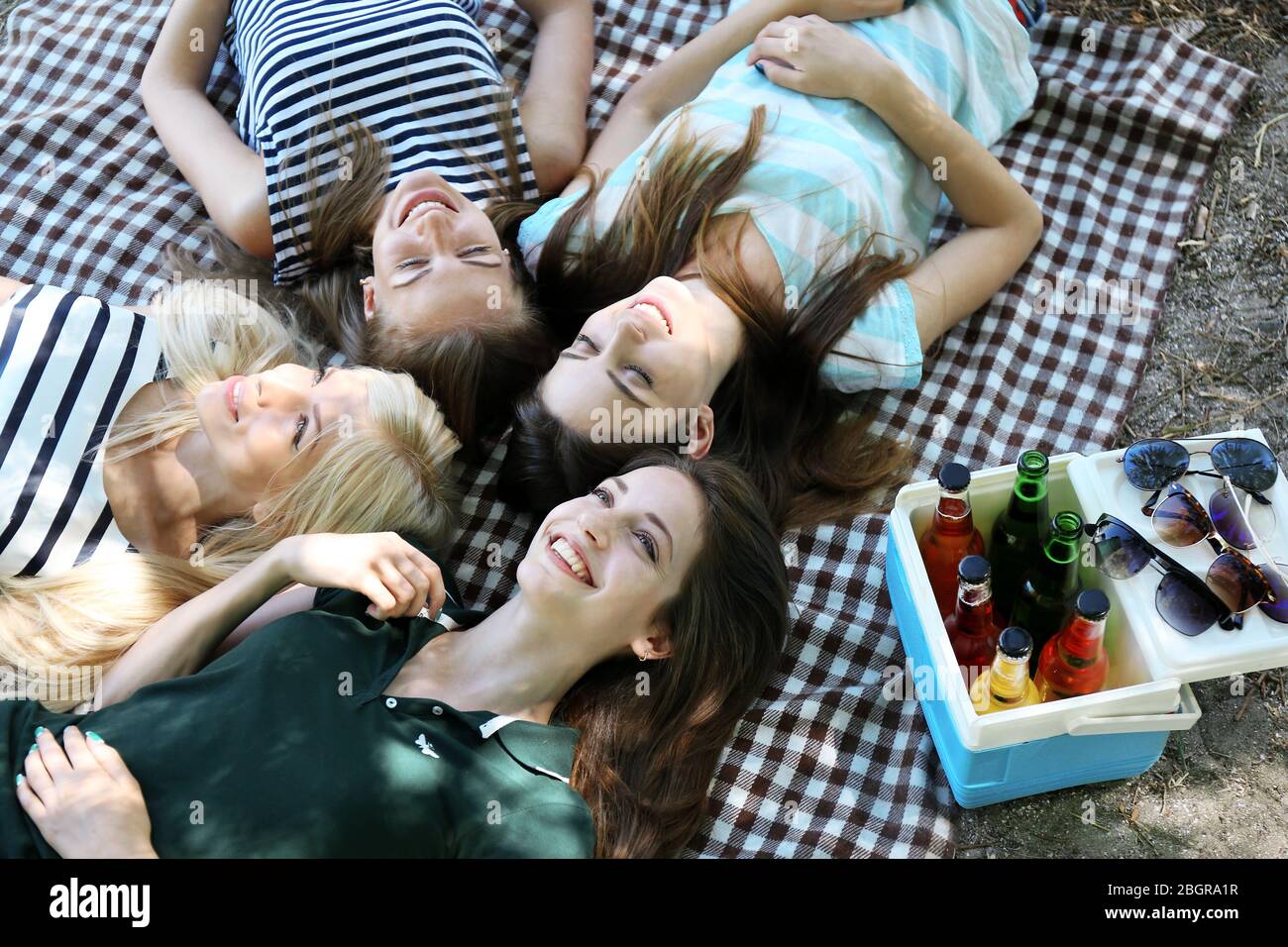 Group of friends having rest at park Stock Photo - Alamy