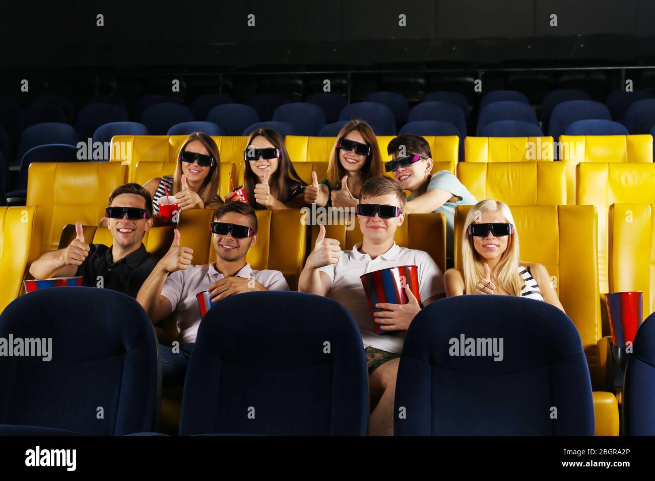 Young people watching movie in cinema Stock Photo - Alamy