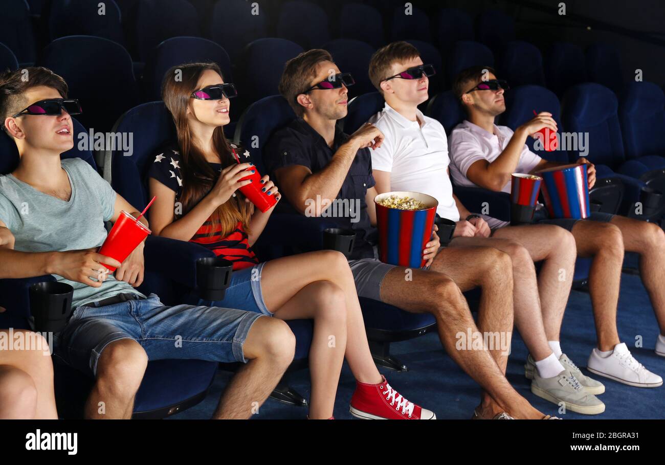 Young people watching movie in cinema Stock Photo - Alamy
