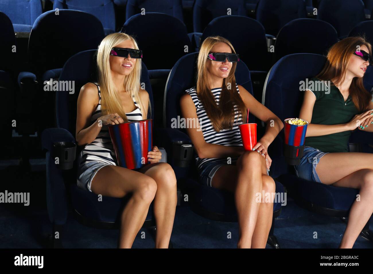 Young people watching movie in cinema Stock Photo - Alamy